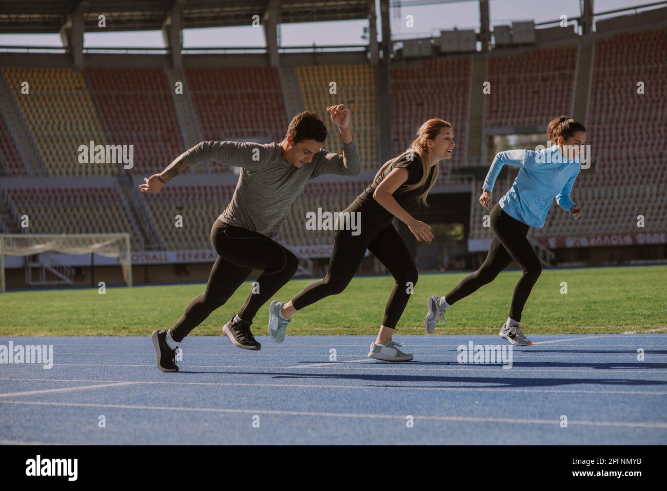Three athletes running up hi-res stock photography and images - Alamy