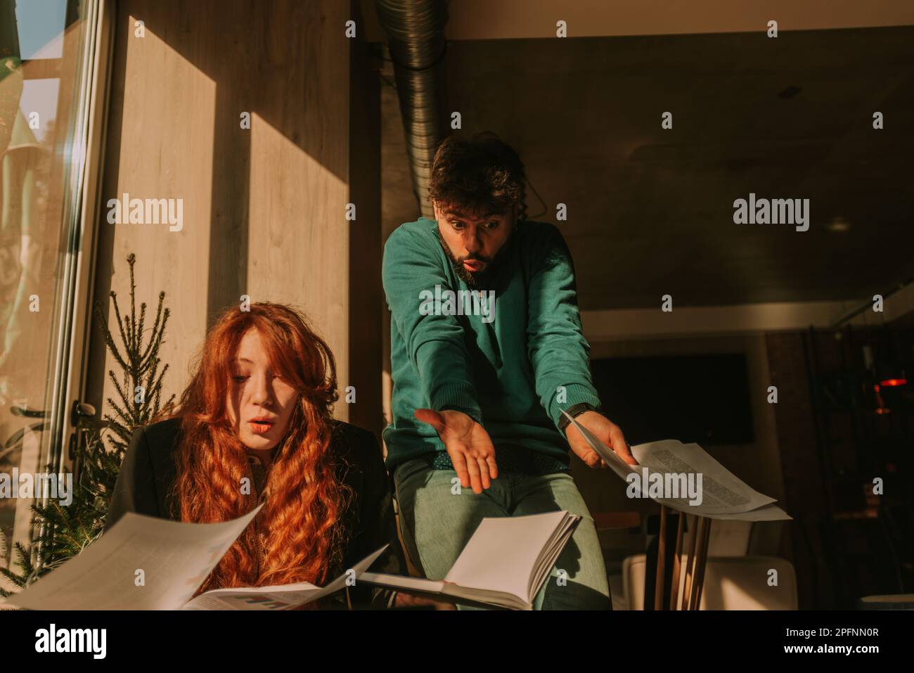 Ginger woman looks scared after her male manager started yelling at her ...