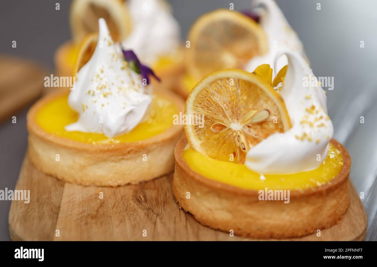Shortbread tart cake decorated with dried lemons and white cream ...