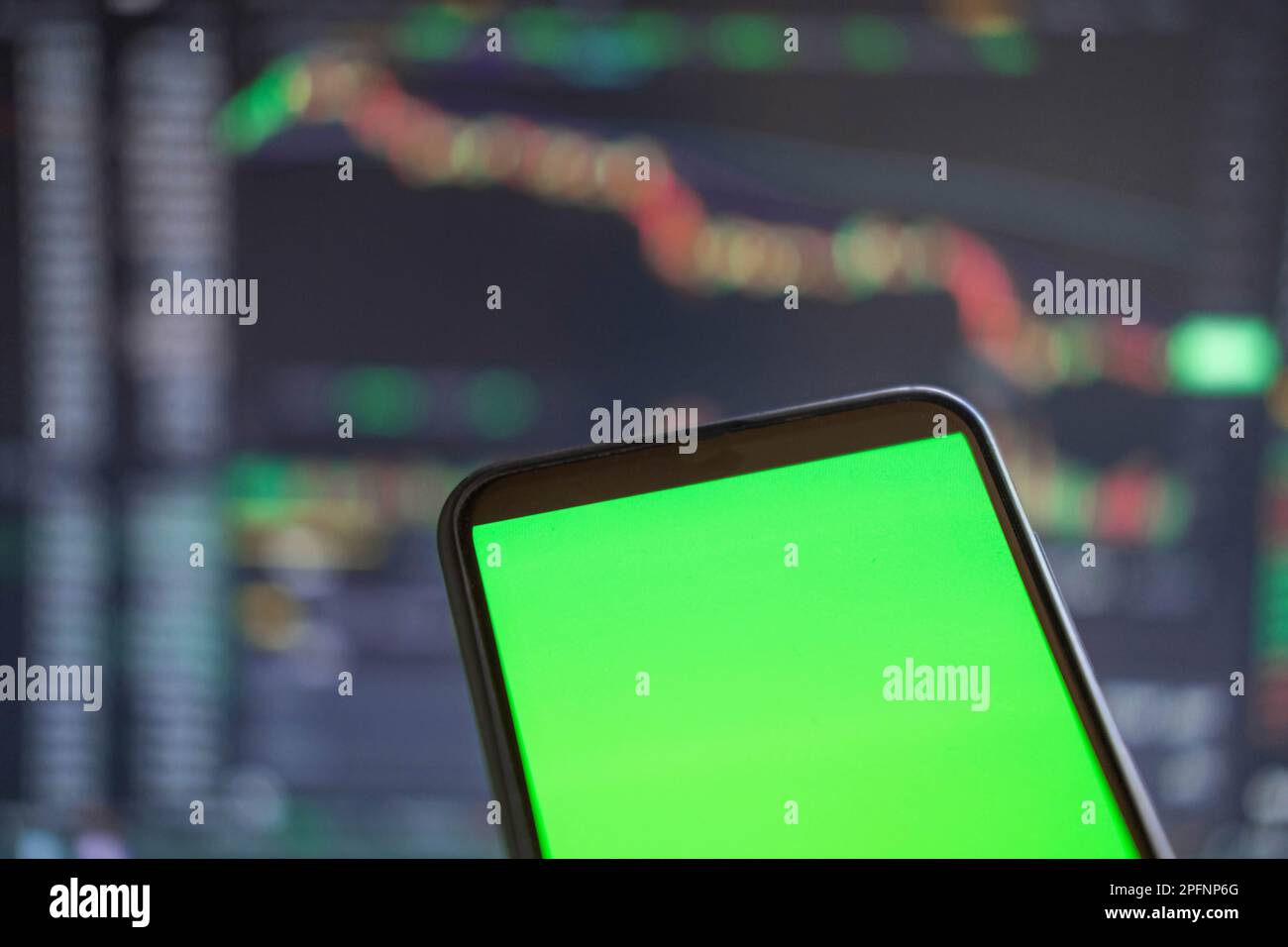 Black phone with blank mockup screen on rising stock graph. Closeup ...