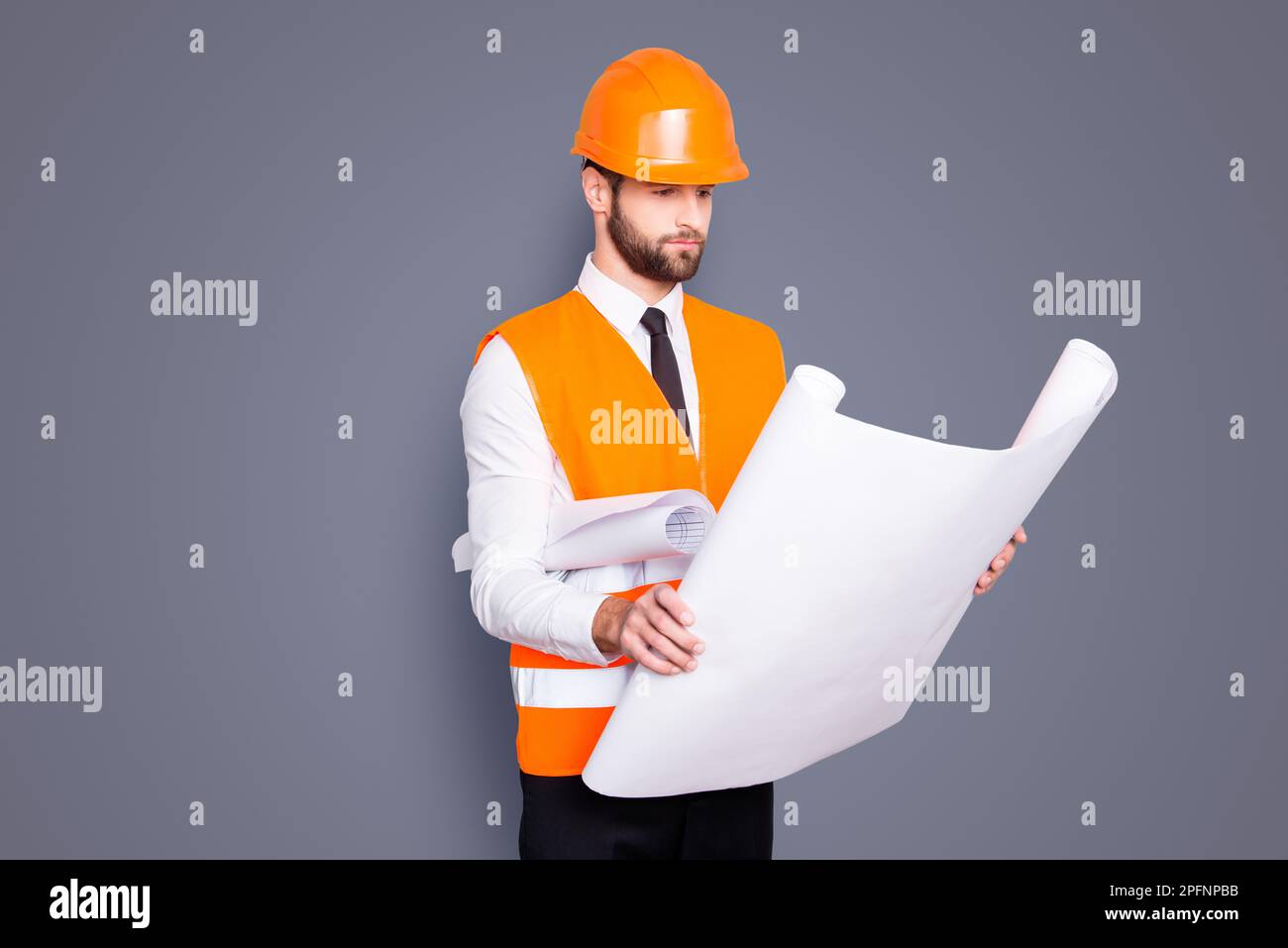 Portrait of busy handsome concentrated architect in shirt, tie and hard ...