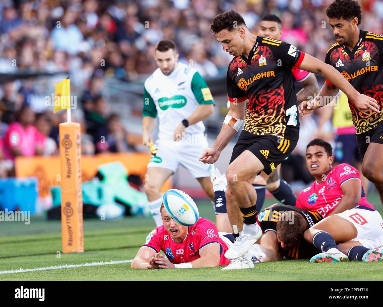 Shaun Stevenson of the Chiefs kicks the ball clear to score a try ...