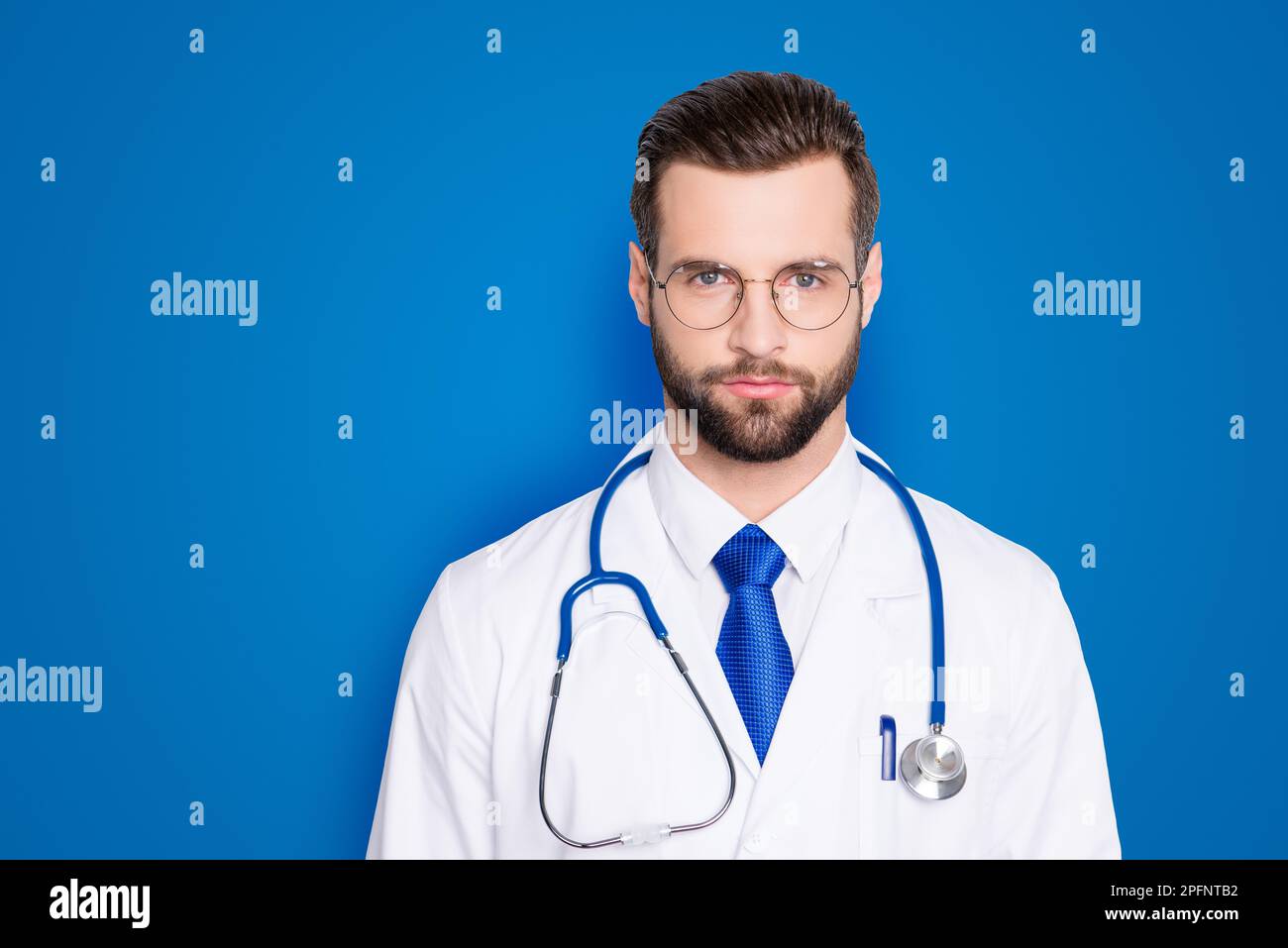 Portrait of trendy modern doc with stubble and modern hairstyle in white lab coat, tie and ...
