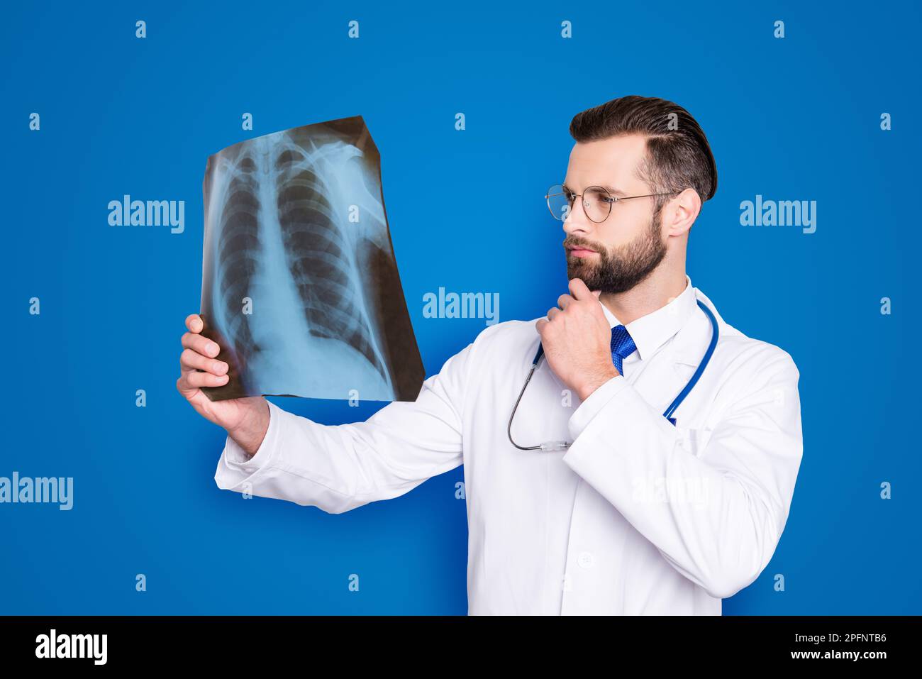 Portrait of pensive minded doc in white lab coat, uniform holding hand ...