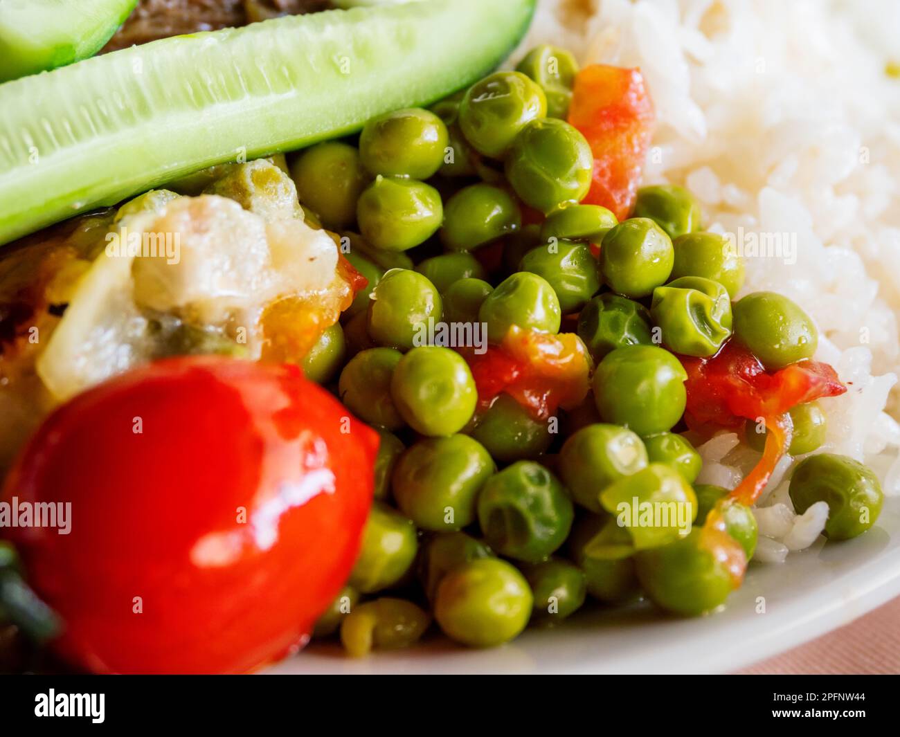 Healthy dinner - plate full of stewed vegetables, rice and peas Stock ...