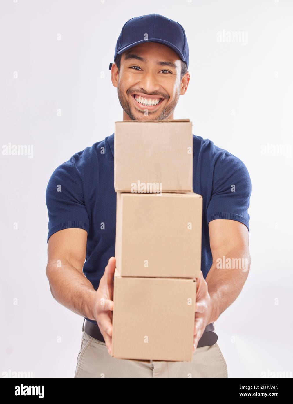 Delivery man, shipping boxes and portrait of a employee in studio with ...
