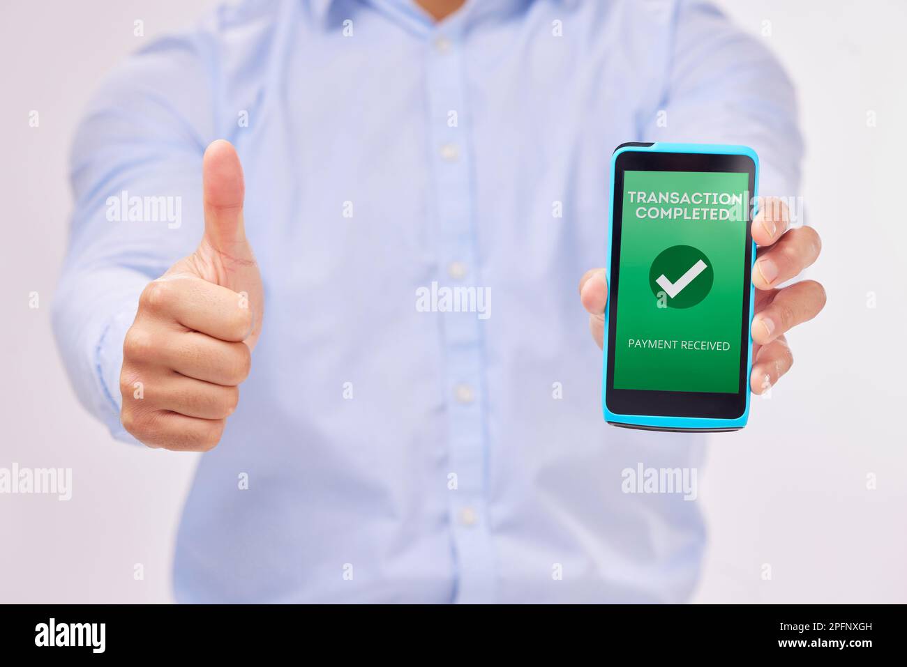 Man, hands and phone with thumbs up for transaction approval against a ...