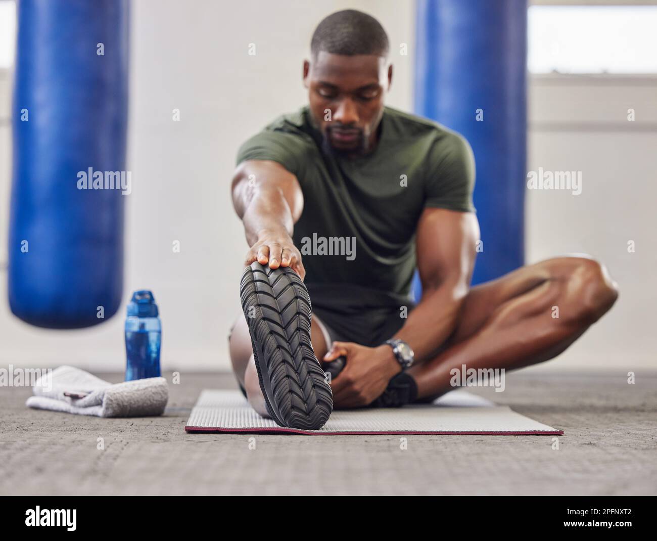 Black man, stretching legs and fitness in gym for training, performance ...