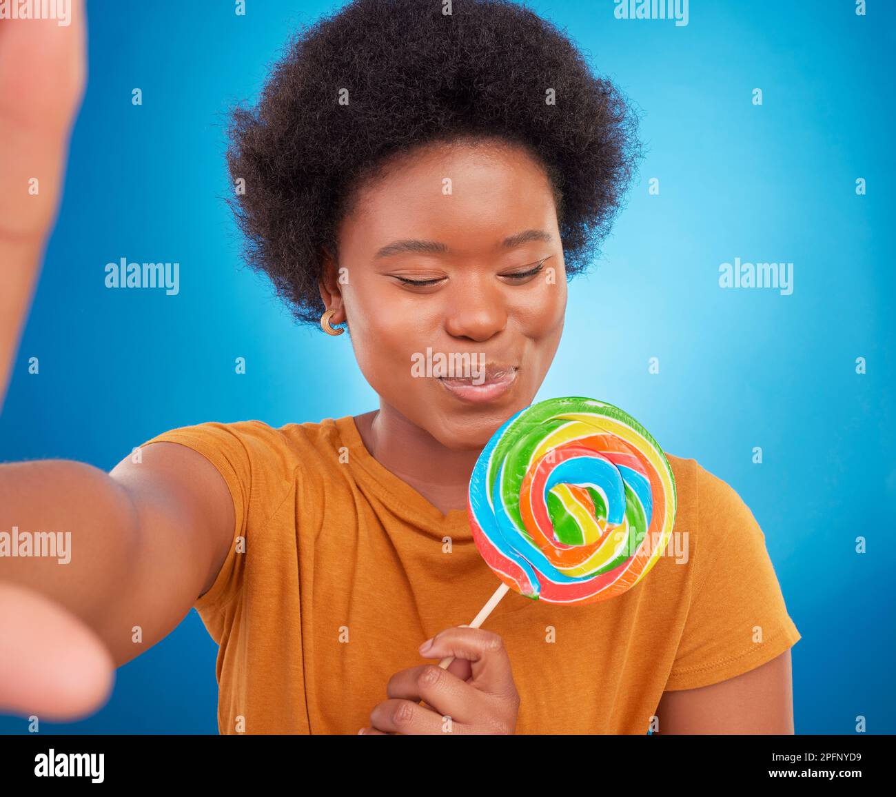 Woman, rainbow lollipop and selfie in studio with a smile and happiness ...