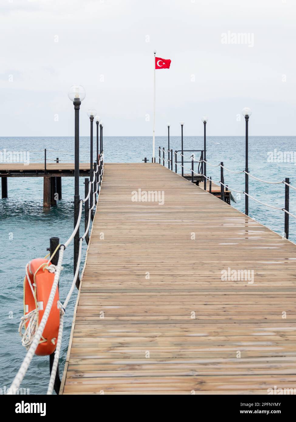Deserted pontoon with orange life buoy and national flag of Turkey ...