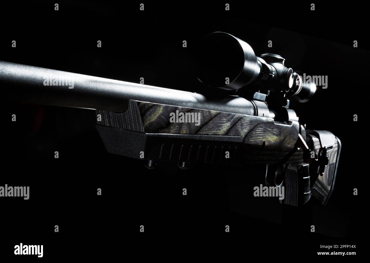 High powered optic on a bolt action rifle with a black background Stock ...