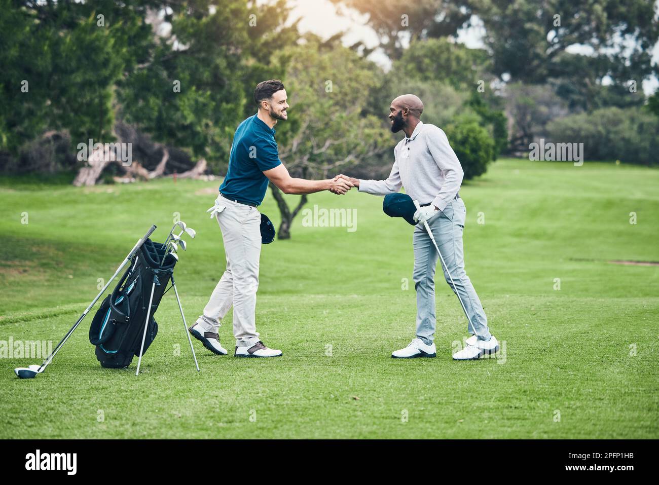 Men, golf course grass and handshake for friends at game, sport and ...