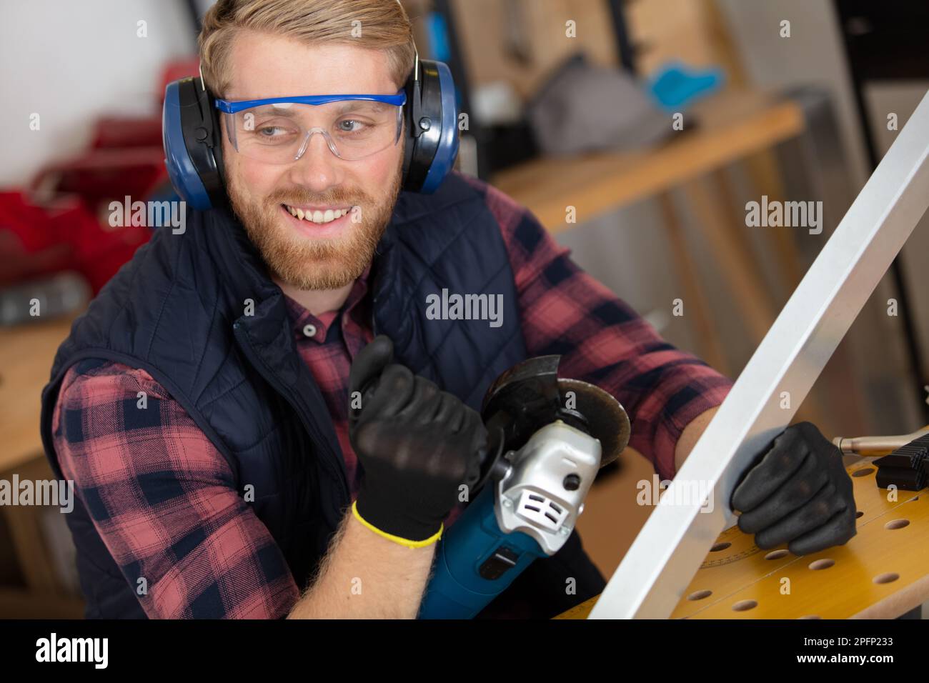 male worker using an angle grinder Stock Photo - Alamy