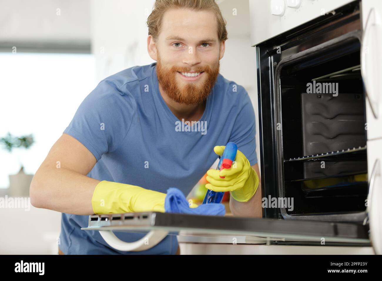 Man cleaning oven in kitchen hi-res stock photography and images - Alamy
