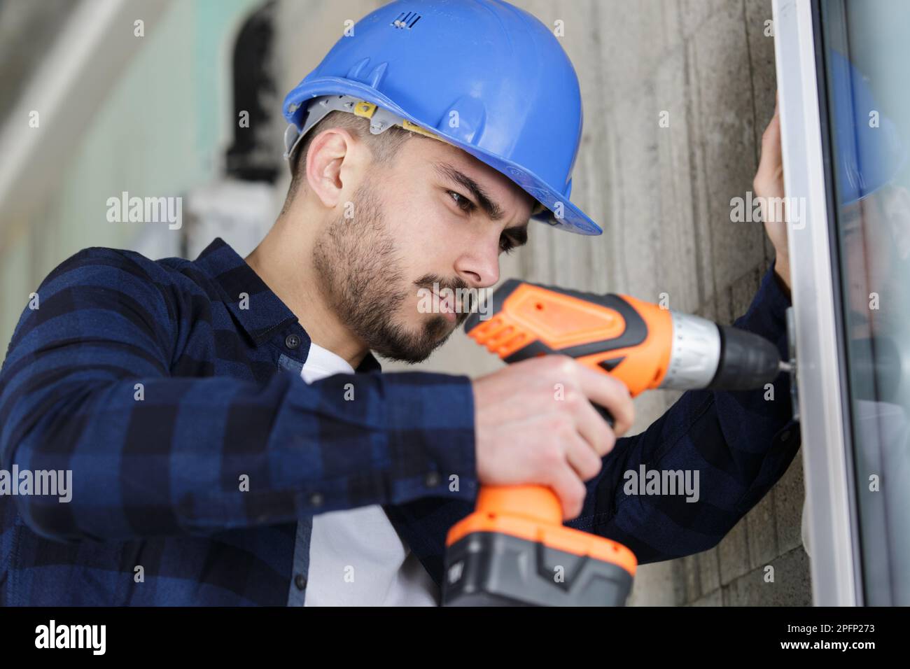 a man drilling window frame Stock Photo - Alamy