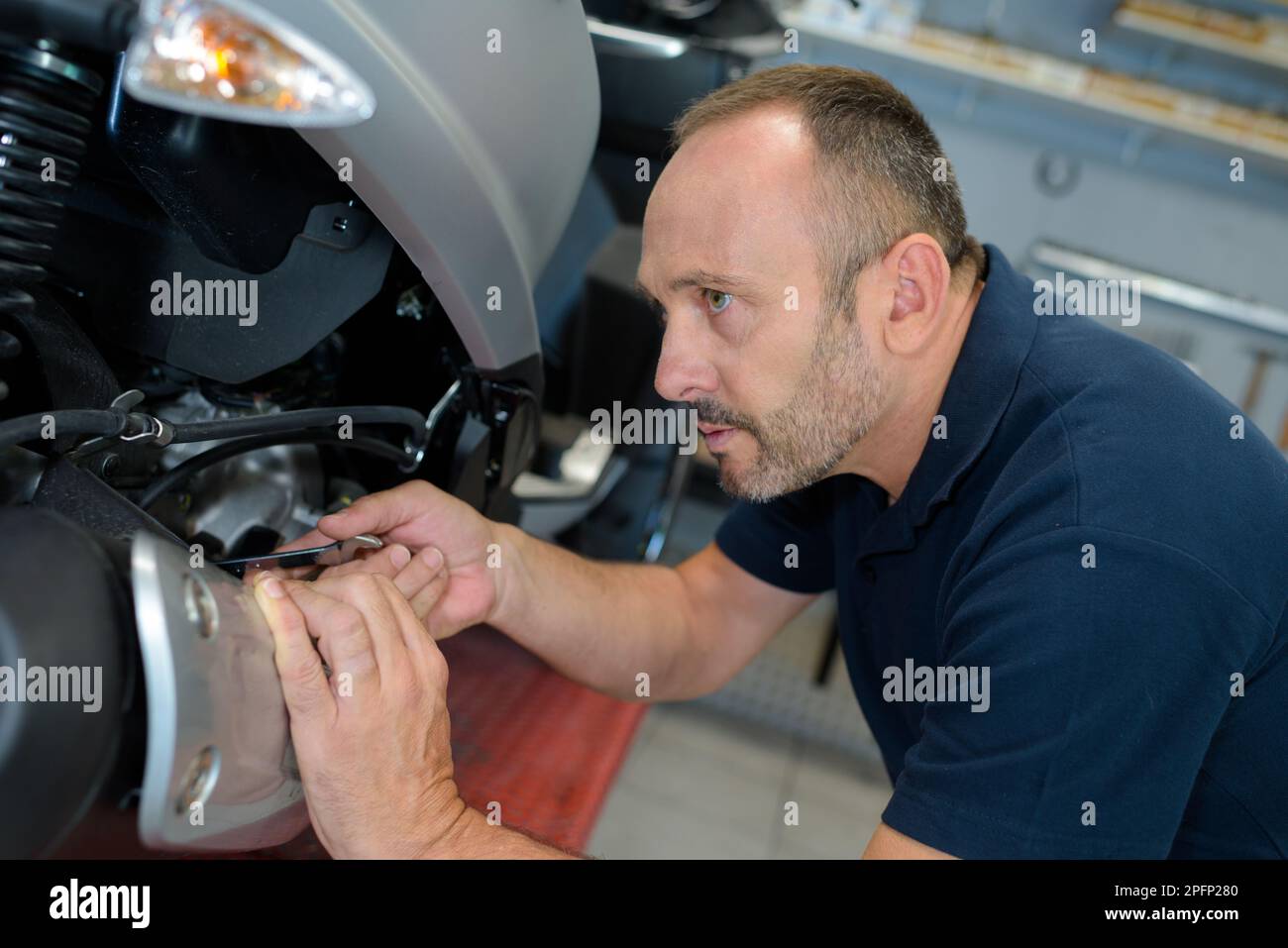Mechanic working on scooter hi-res stock photography and images - Alamy