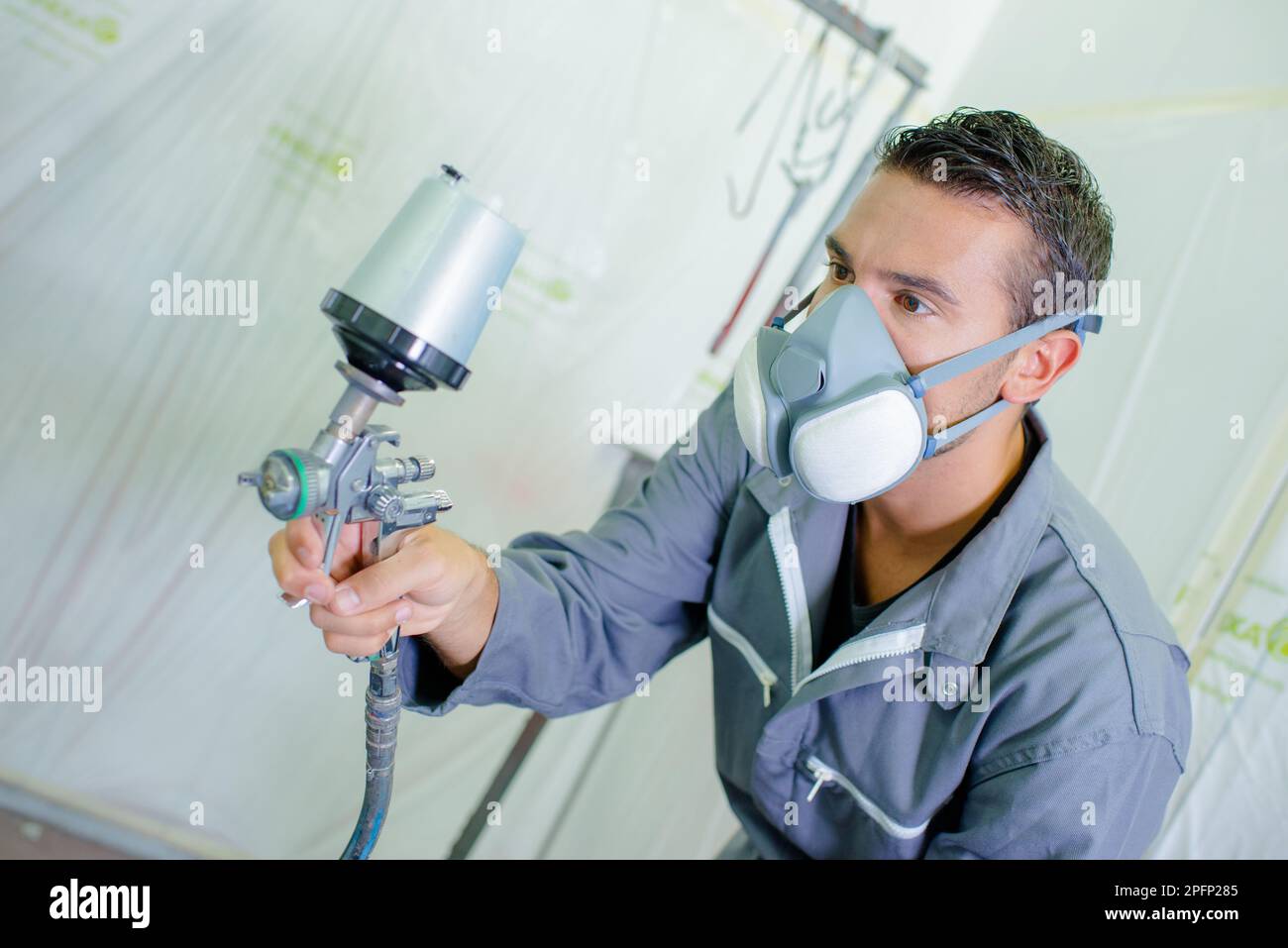 Worker using machine coating hi-res stock photography and images - Alamy