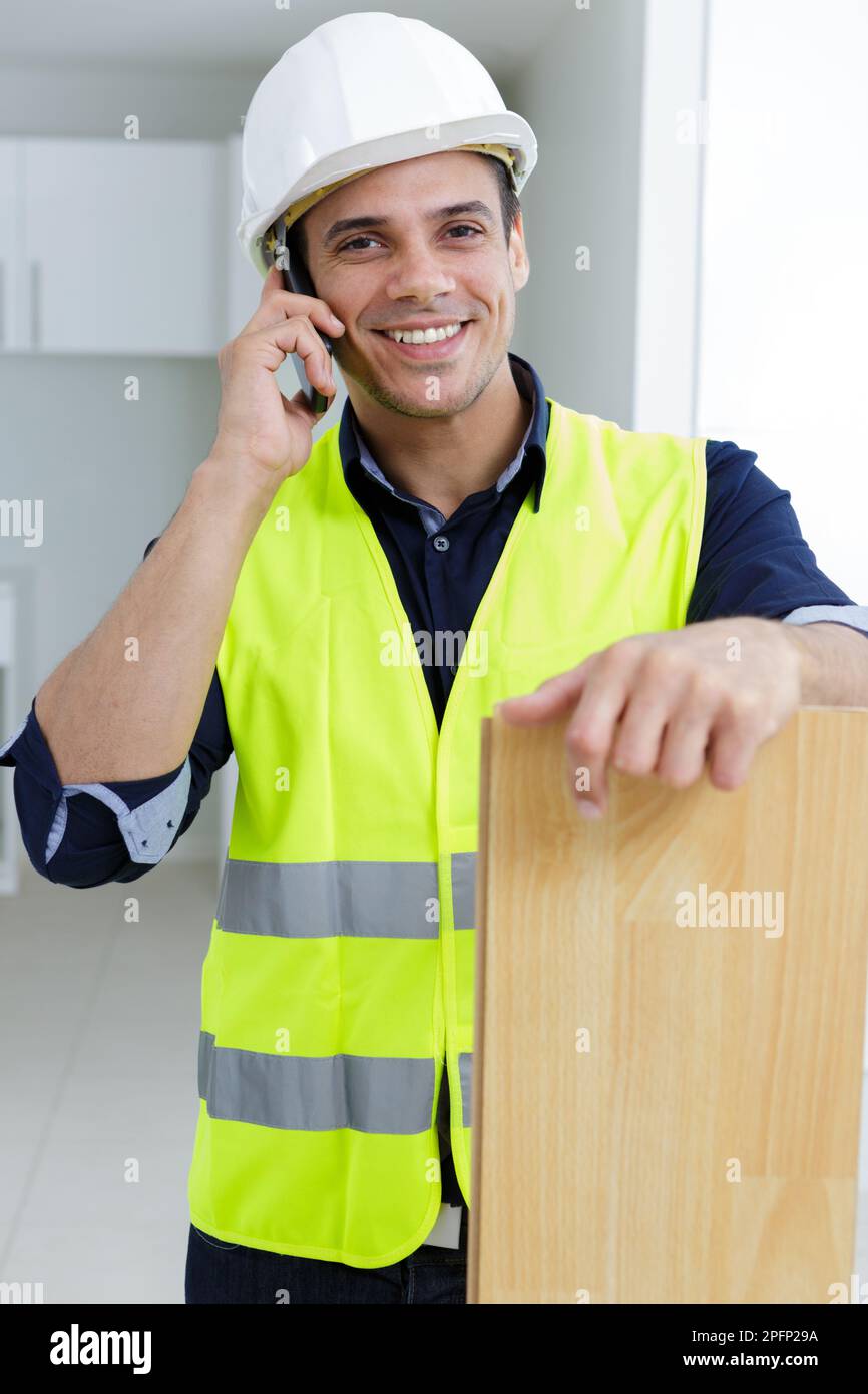 portrait of construction worker discussing floor plans inside Stock ...
