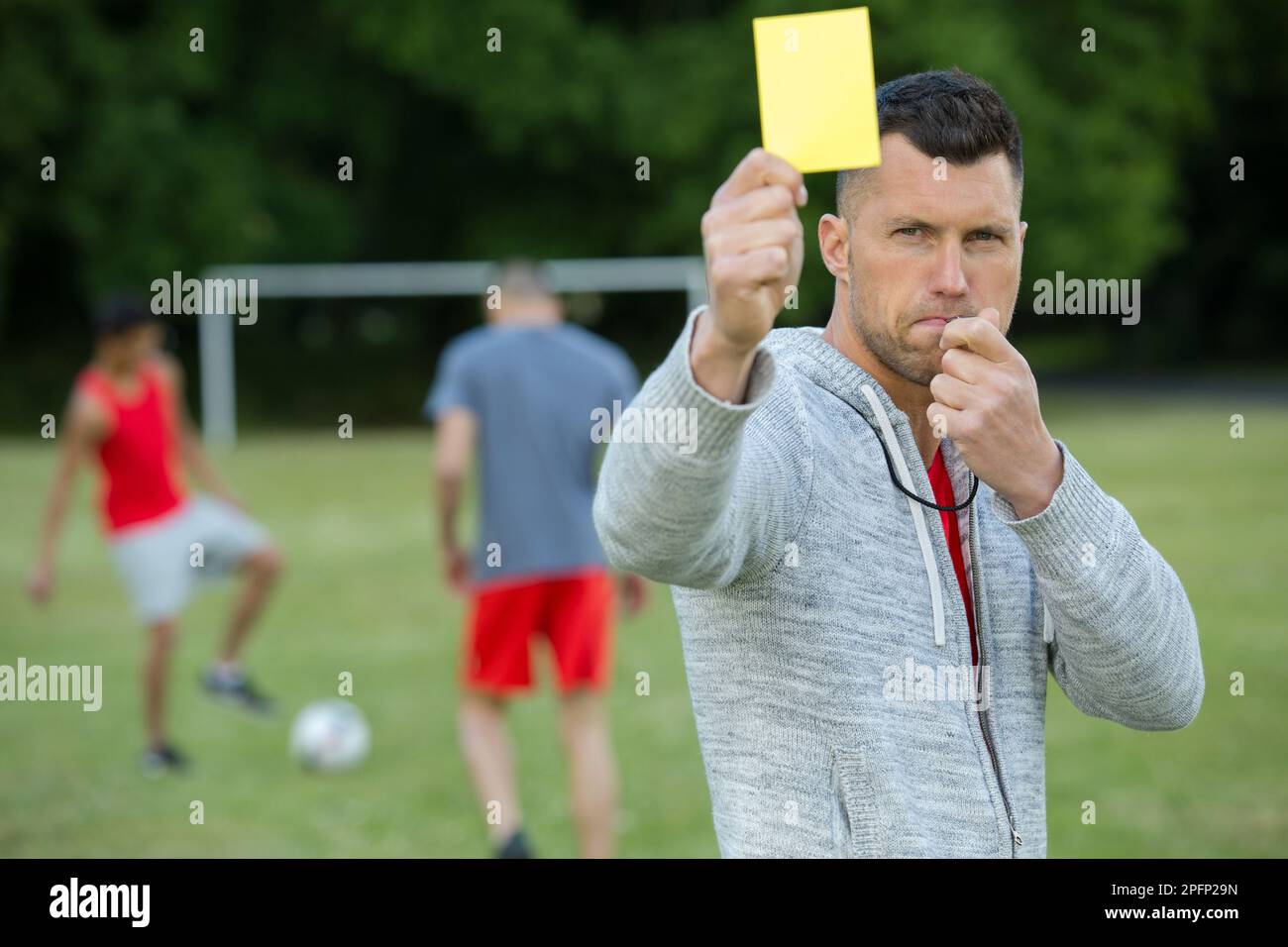 a referee showing yellow card Stock Photo - Alamy