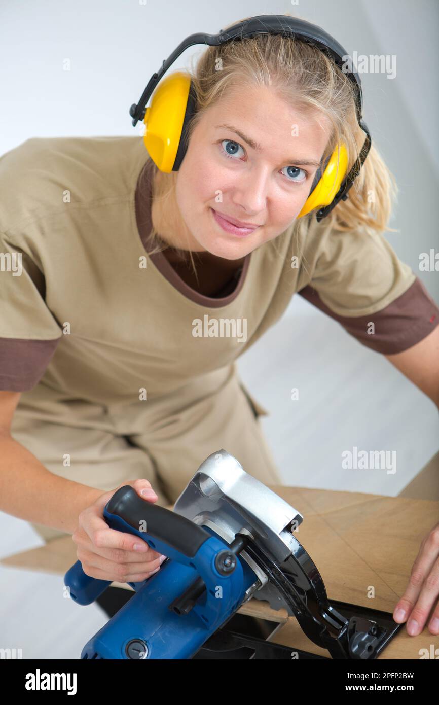 female carpenter using some power tools for her work Stock Photo - Alamy