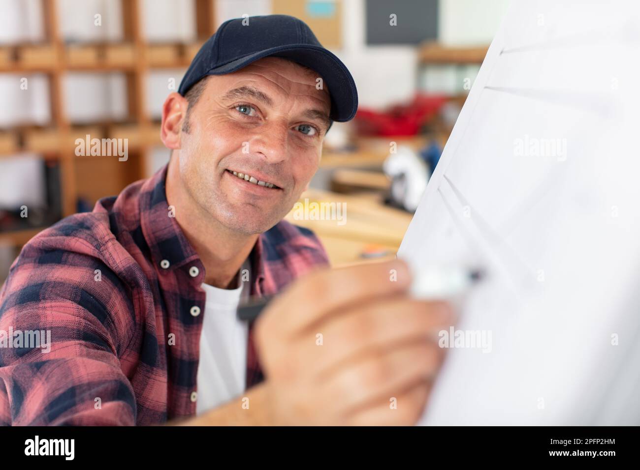 local carpenter at work smiling Stock Photo - Alamy
