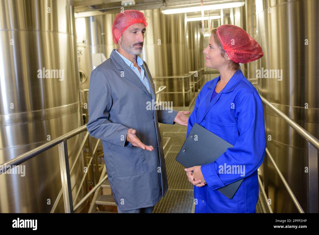 two workers having a conversation Stock Photo - Alamy