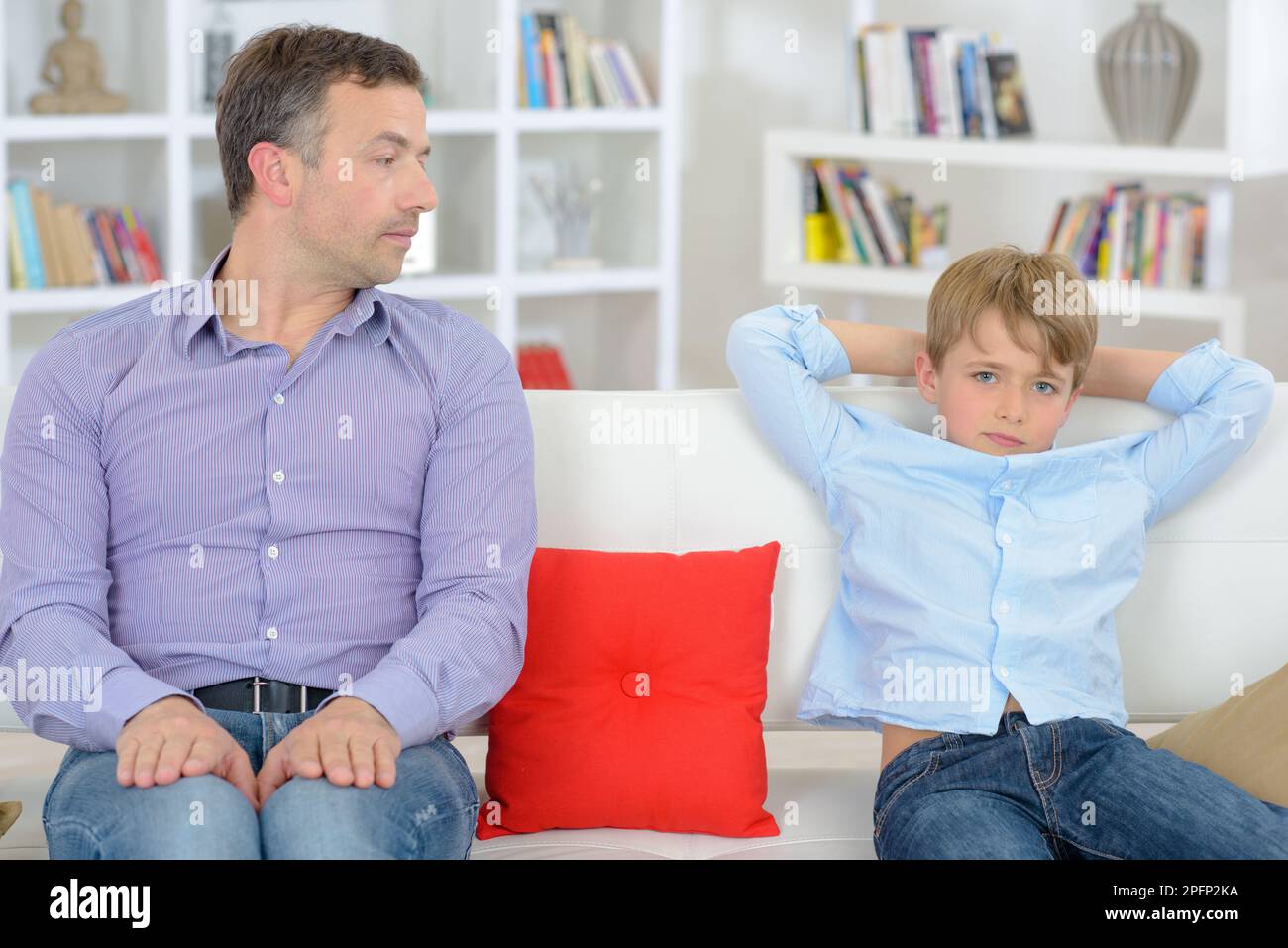 Father and son sitting separately not talking to eachother Stock Photo ...