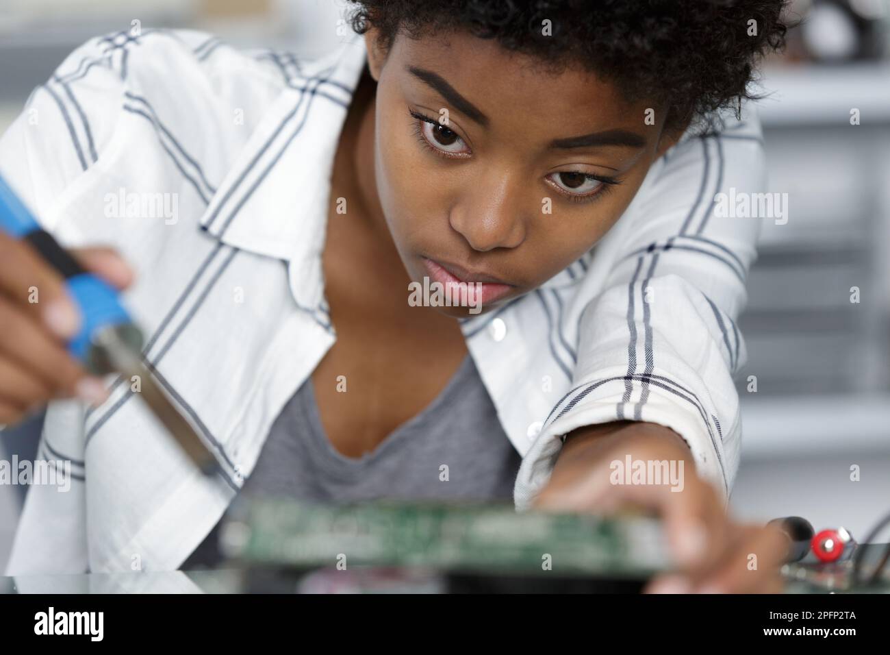 female engineer fixing broken computer hard drive Stock Photo - Alamy