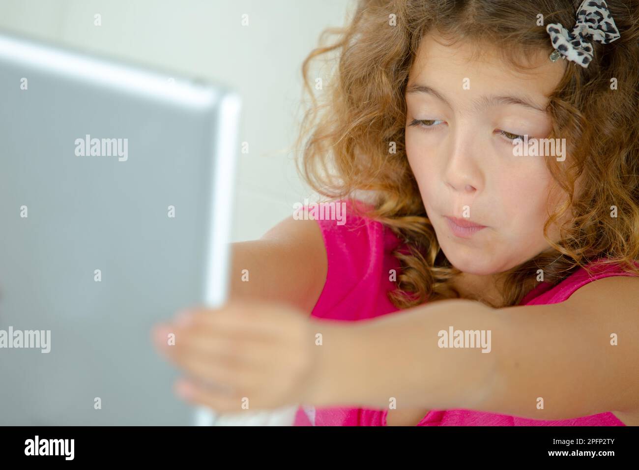 a child pulling a face Stock Photo - Alamy