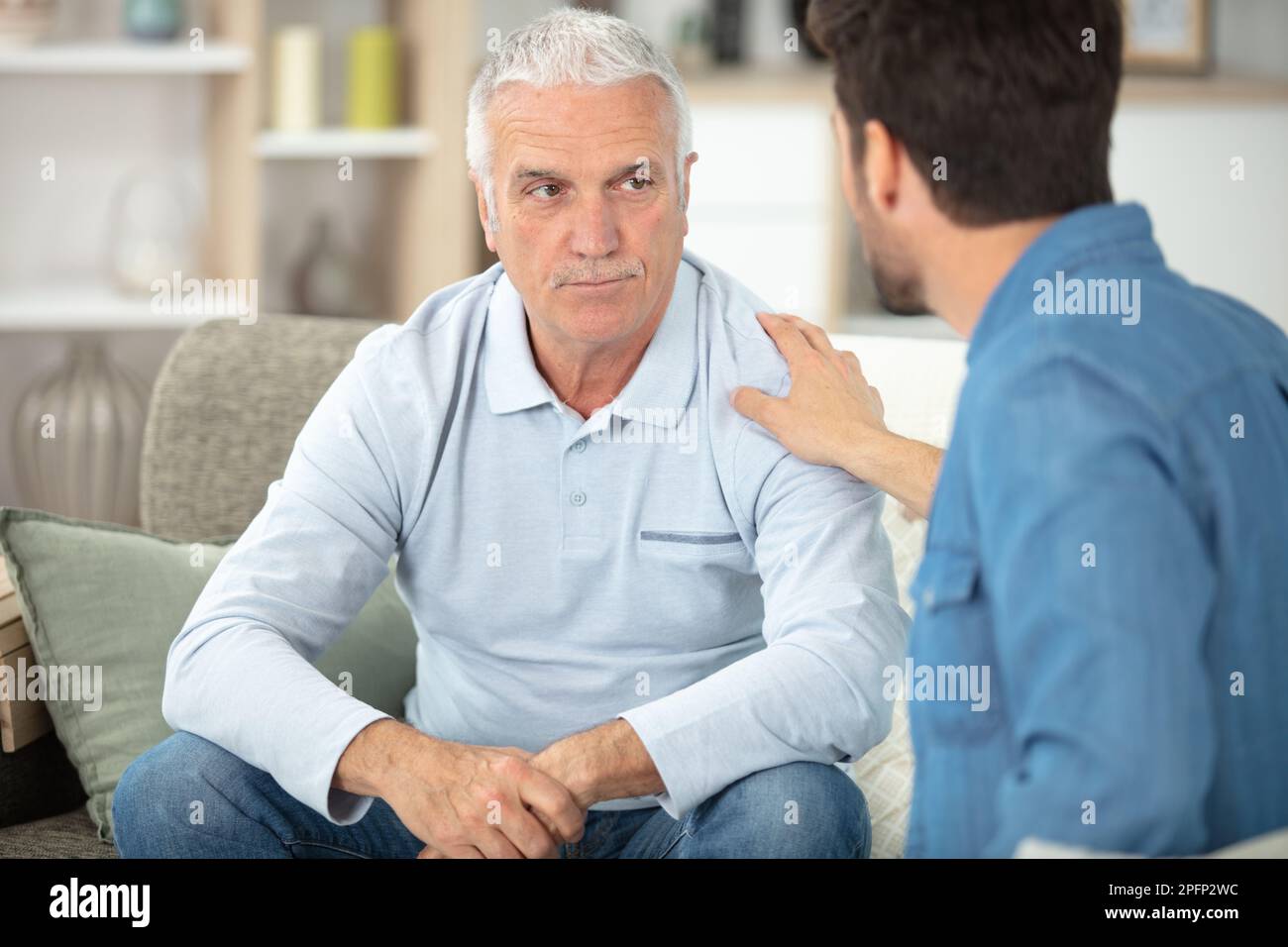 aged man depressed have friends encouraging him Stock Photo - Alamy