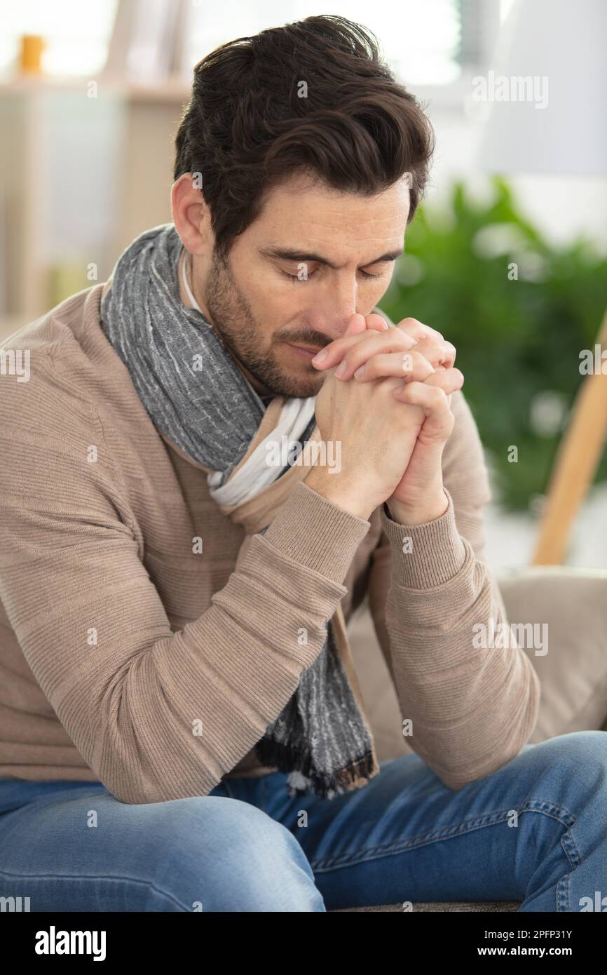 young handsome man begging and praying with hands together Stock Photo ...