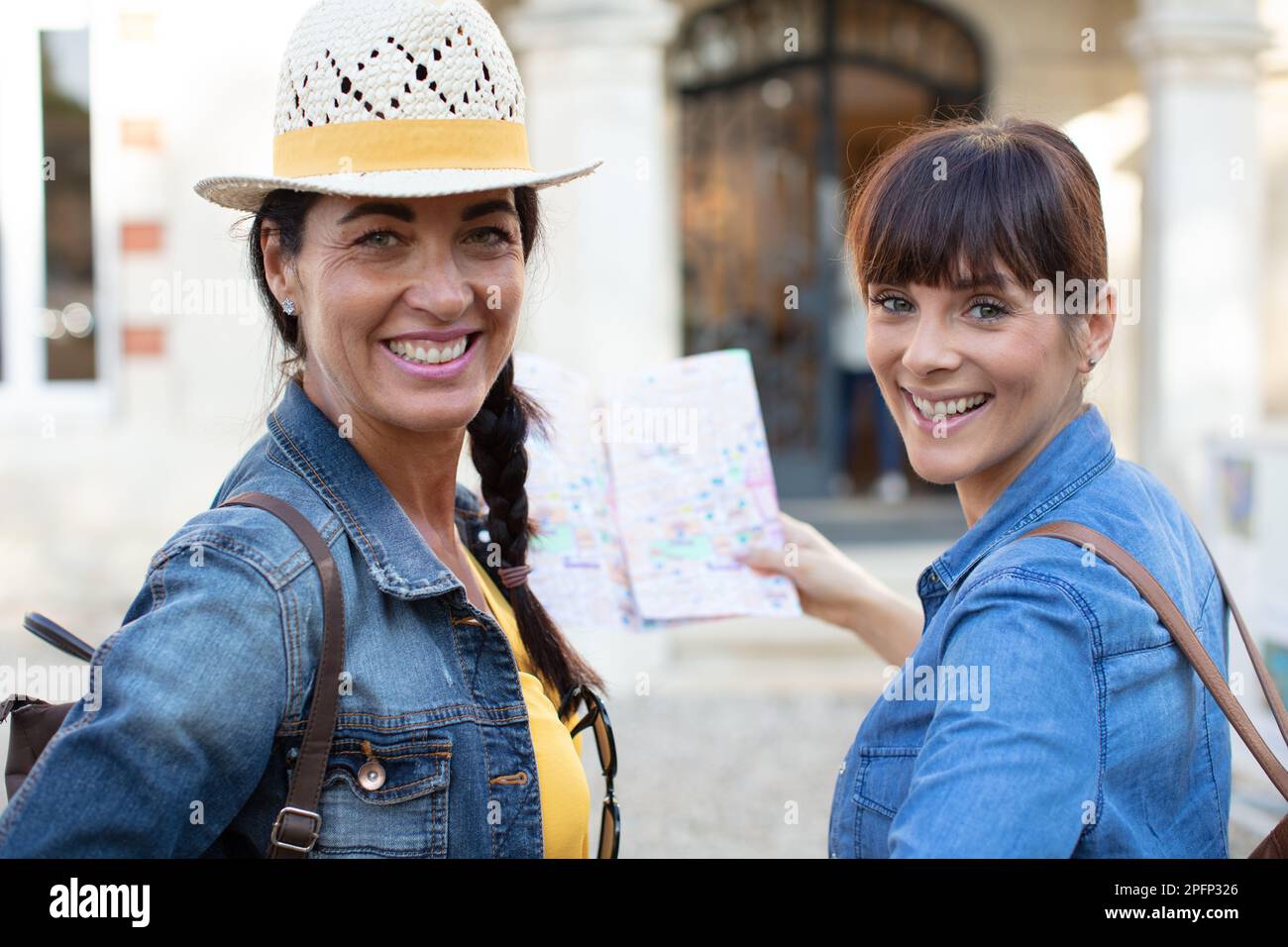 two middle-aged women look at map while on city break Stock Photo - Alamy