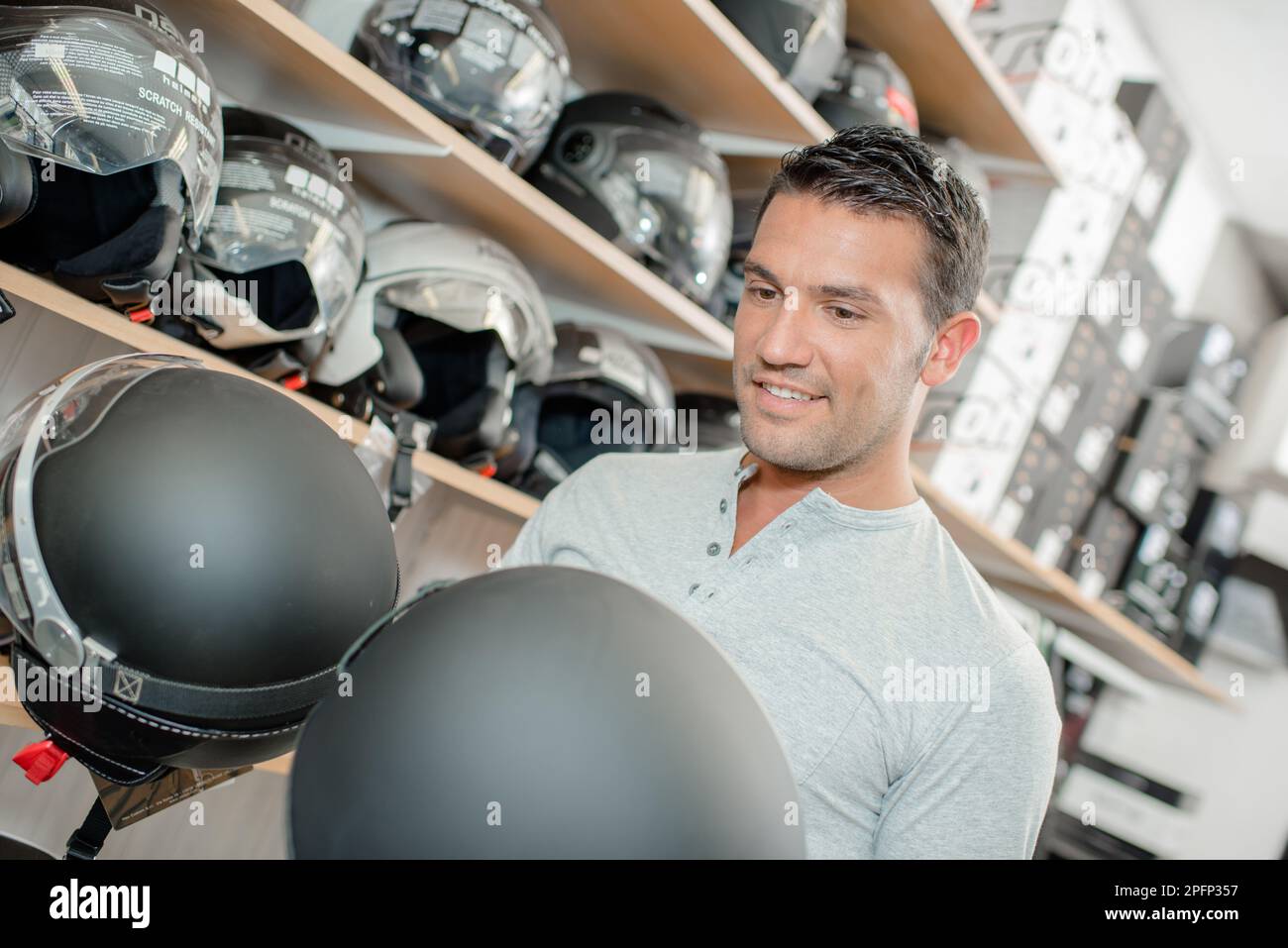 Man comparing helmet hi-res stock photography and images - Alamy