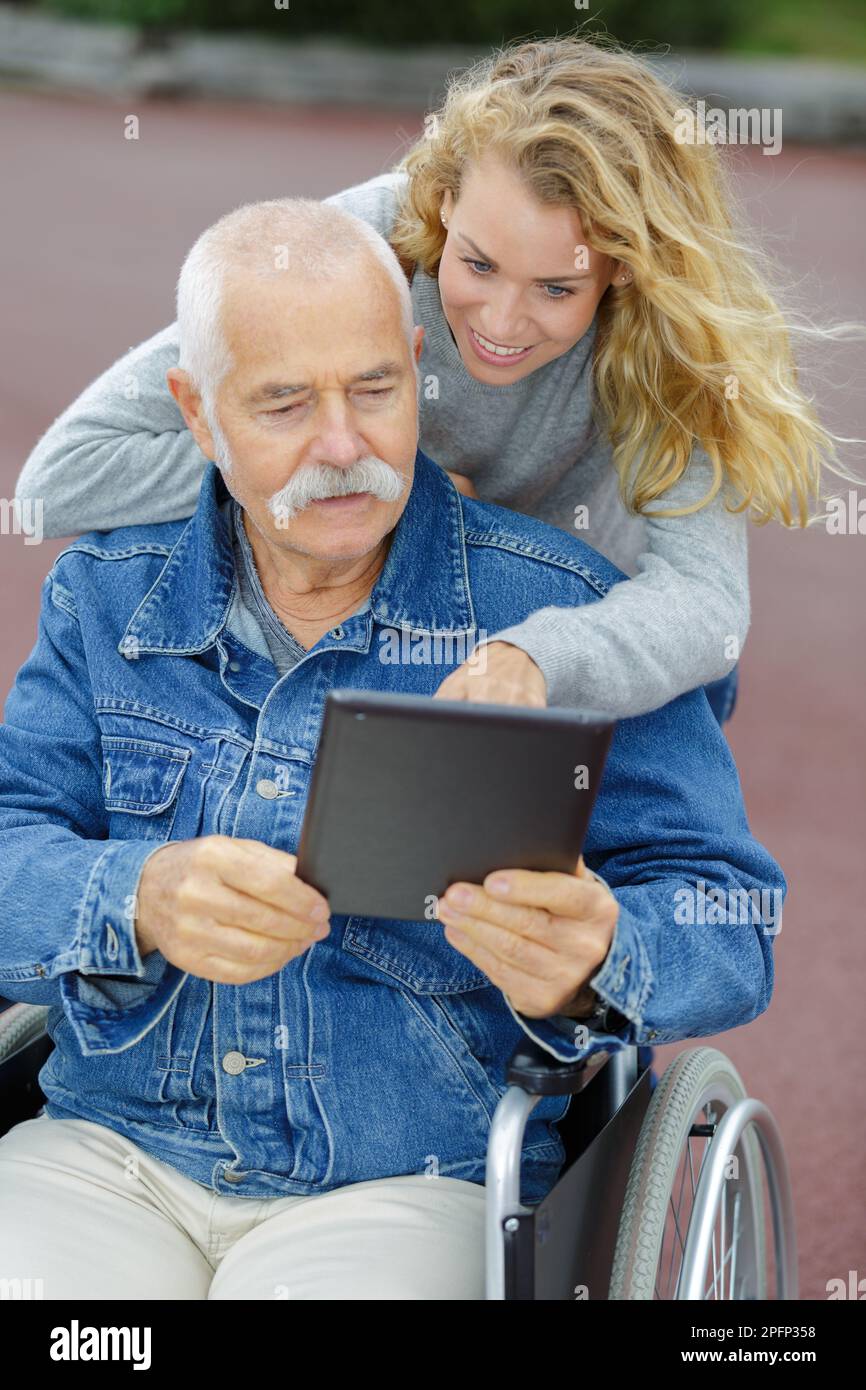 older man browsing the internet with a tablet outdoors Stock Photo - Alamy
