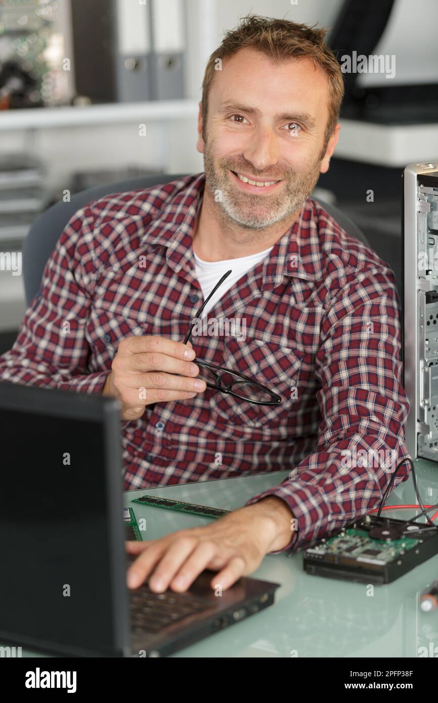 happy it technician looking at camera Stock Photo - Alamy