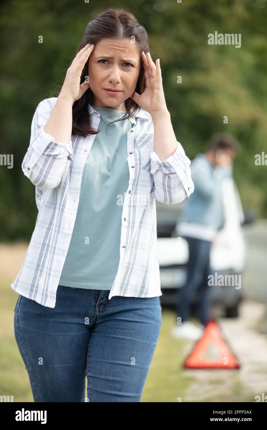 woman looking stressed after breakdown on street Stock Photo - Alamy