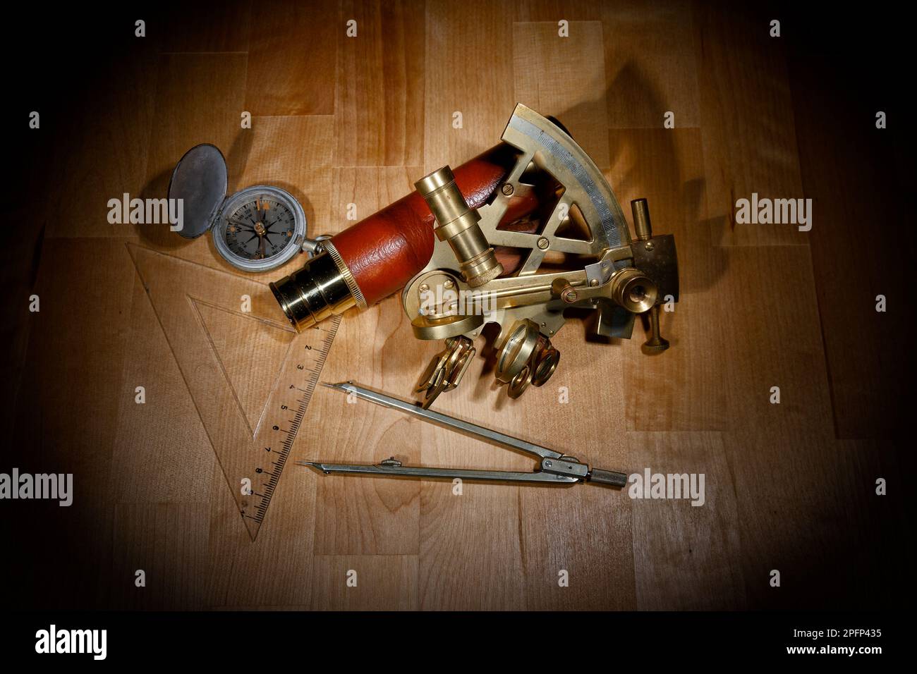 old sextant, spyglass, circle and compass lying on wooden table Stock ...