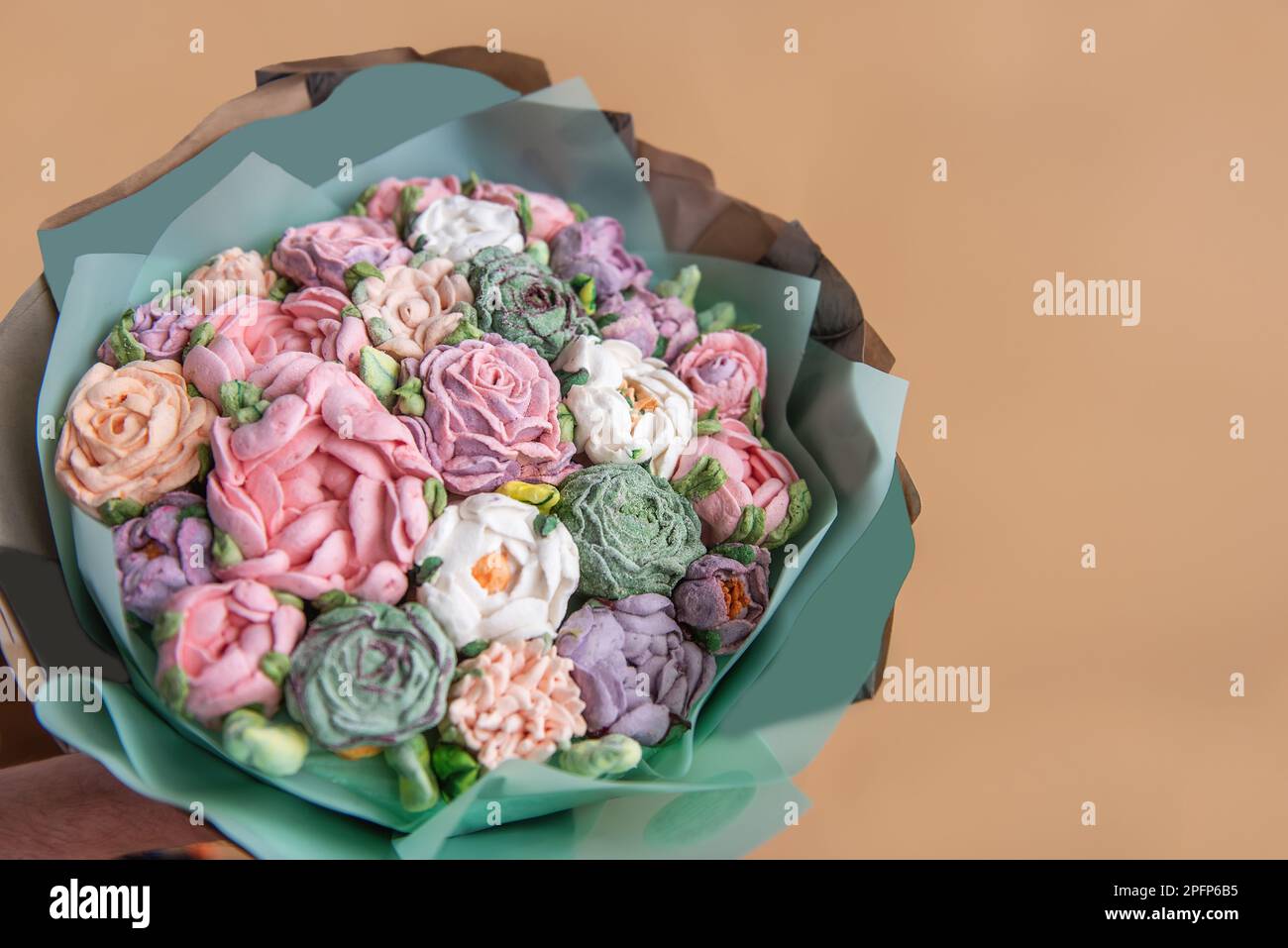 Festive bouquet of sweet sugar marshmallow rose flowers on beige ...