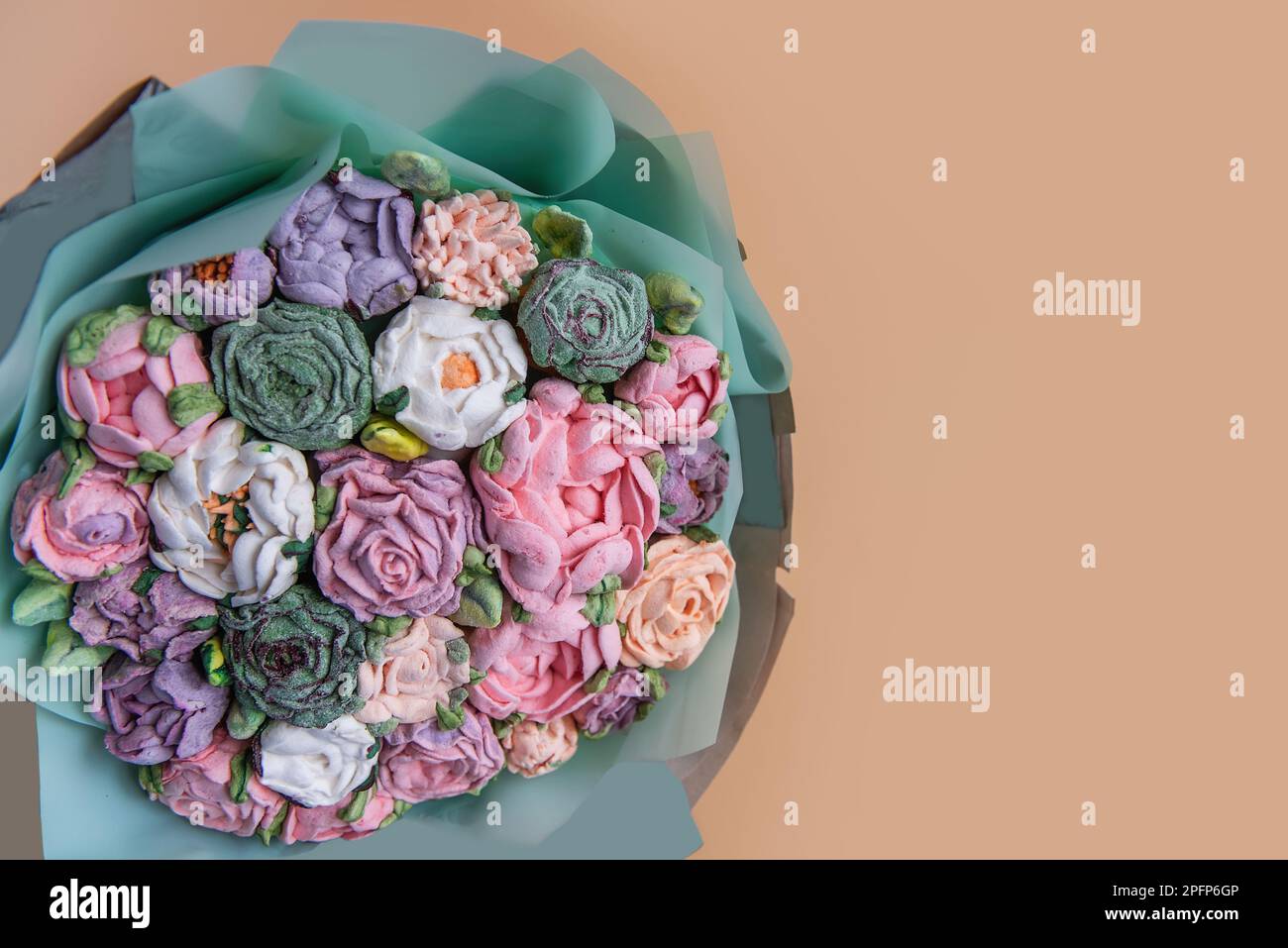 Festive bouquet of sweet sugar marshmallow rose flowers on beige ...