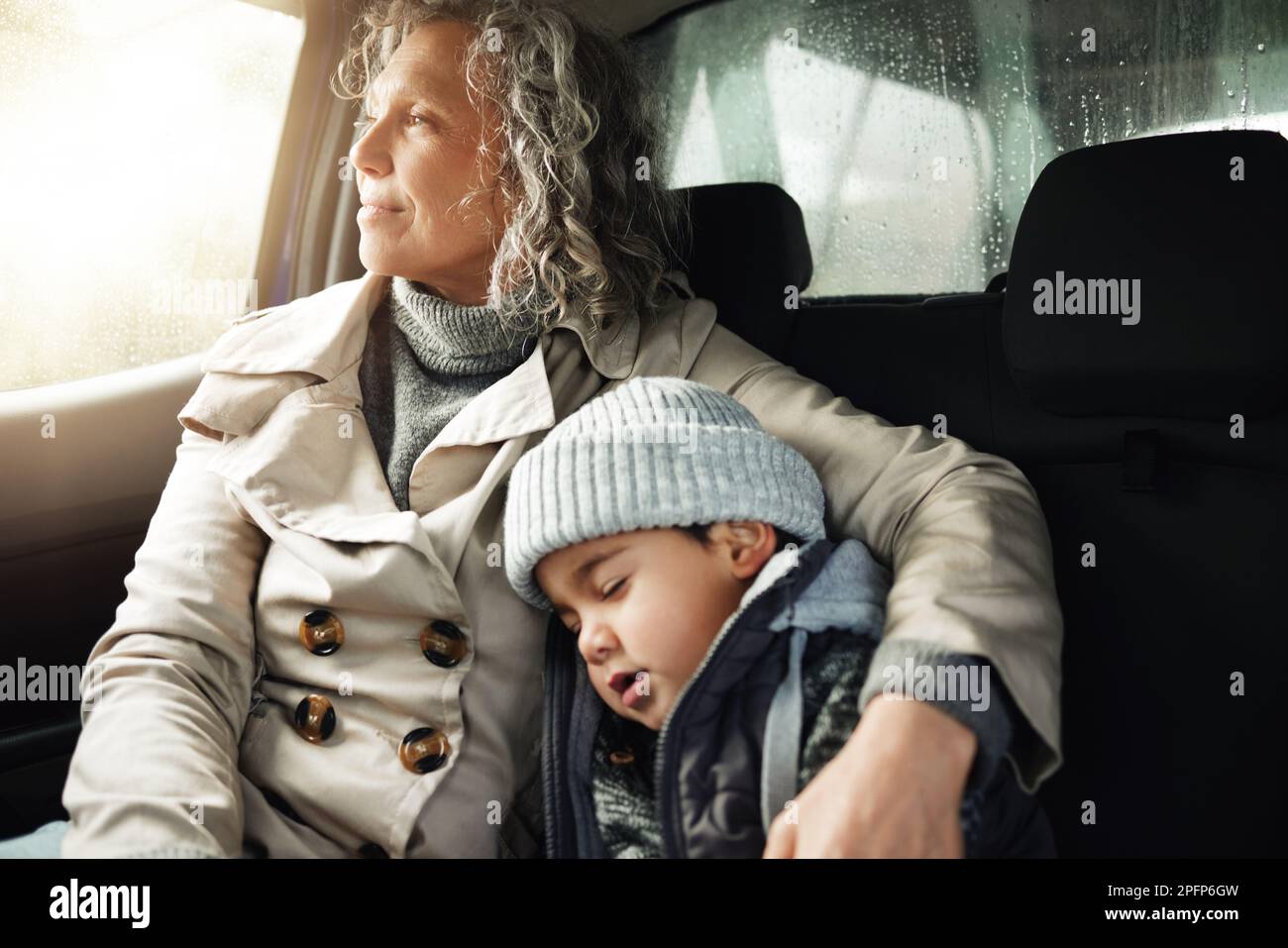 Road trip hug, sleeping child and grandma rest on travel adventure for ...