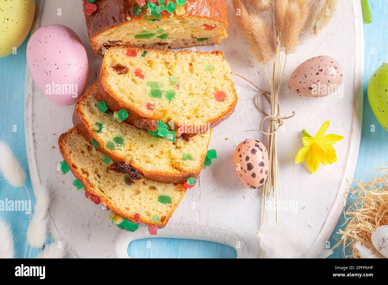 Sweet Fruitcake for Easter surrounded by eggs and spring flowers ...
