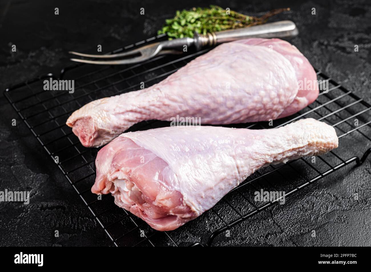 Raw turkey legs on a butcher table. Black background. Top view Stock ...