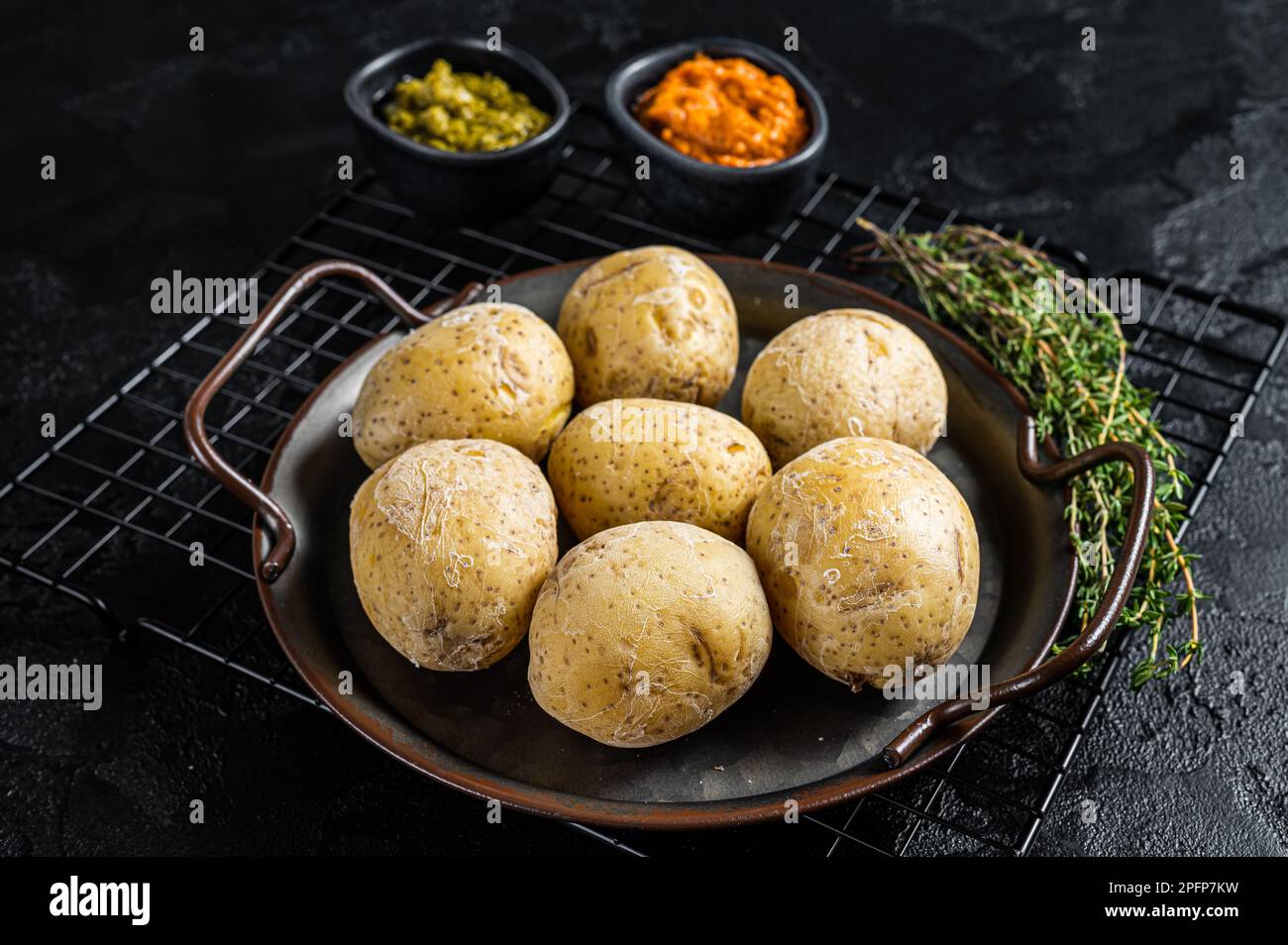 Canarian potatoes papas arrugadas with mojo, hot sauce. Black ...