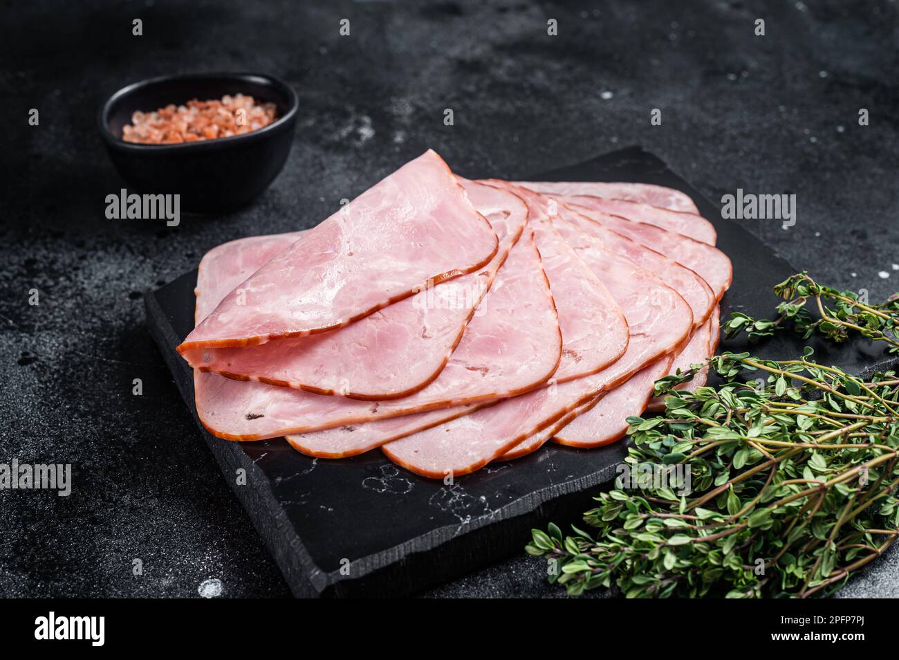 Squared slices of lean pork ham. Black background. Top view Stock Photo ...