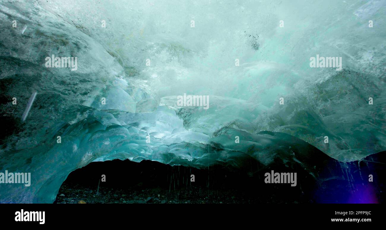 The ice under the rocks gradually melts and forms rivers. Turquoise ice ...