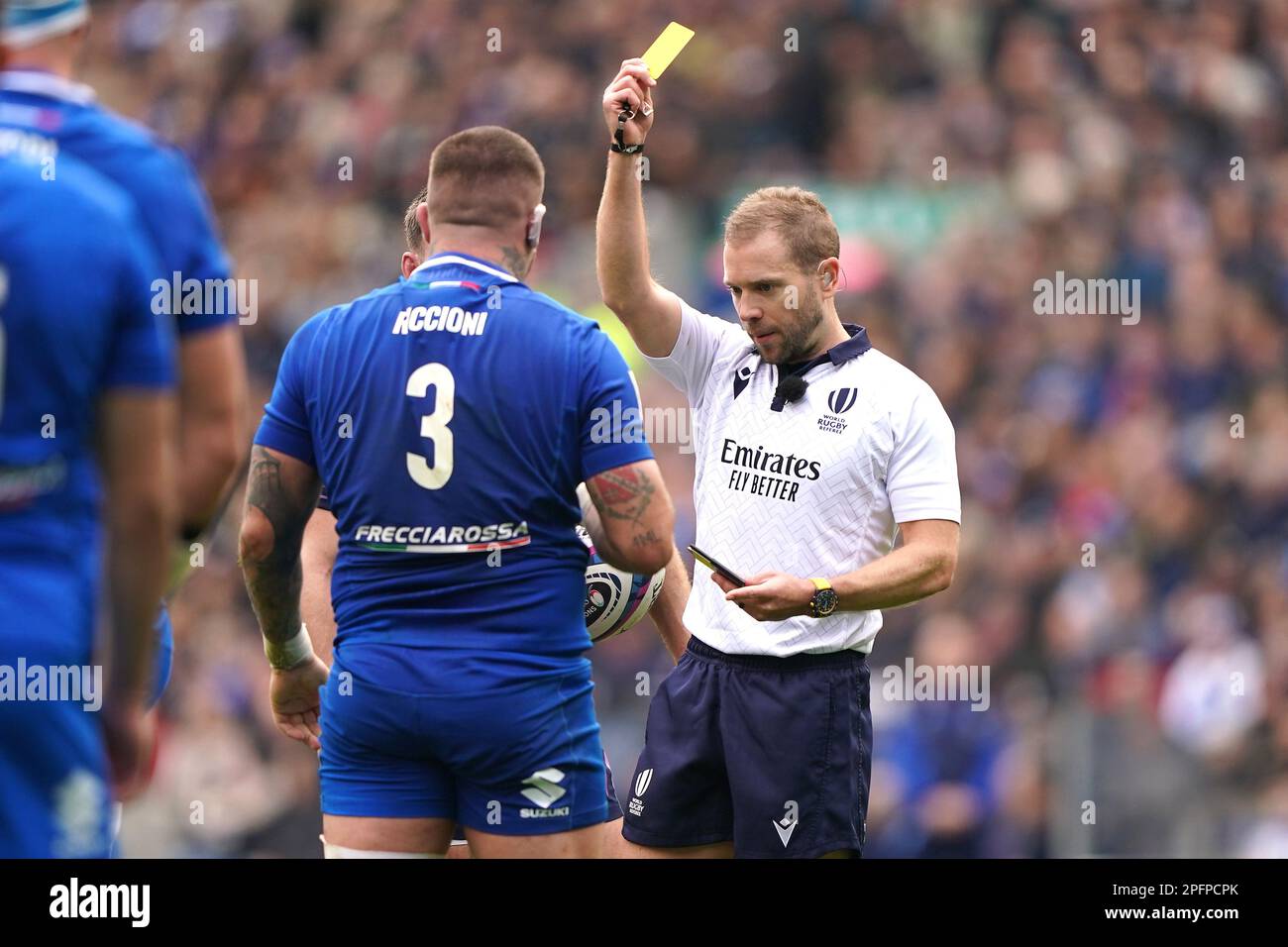 Italy's Marco Riccioni (left) is shown a yellow card by referee Angus ...