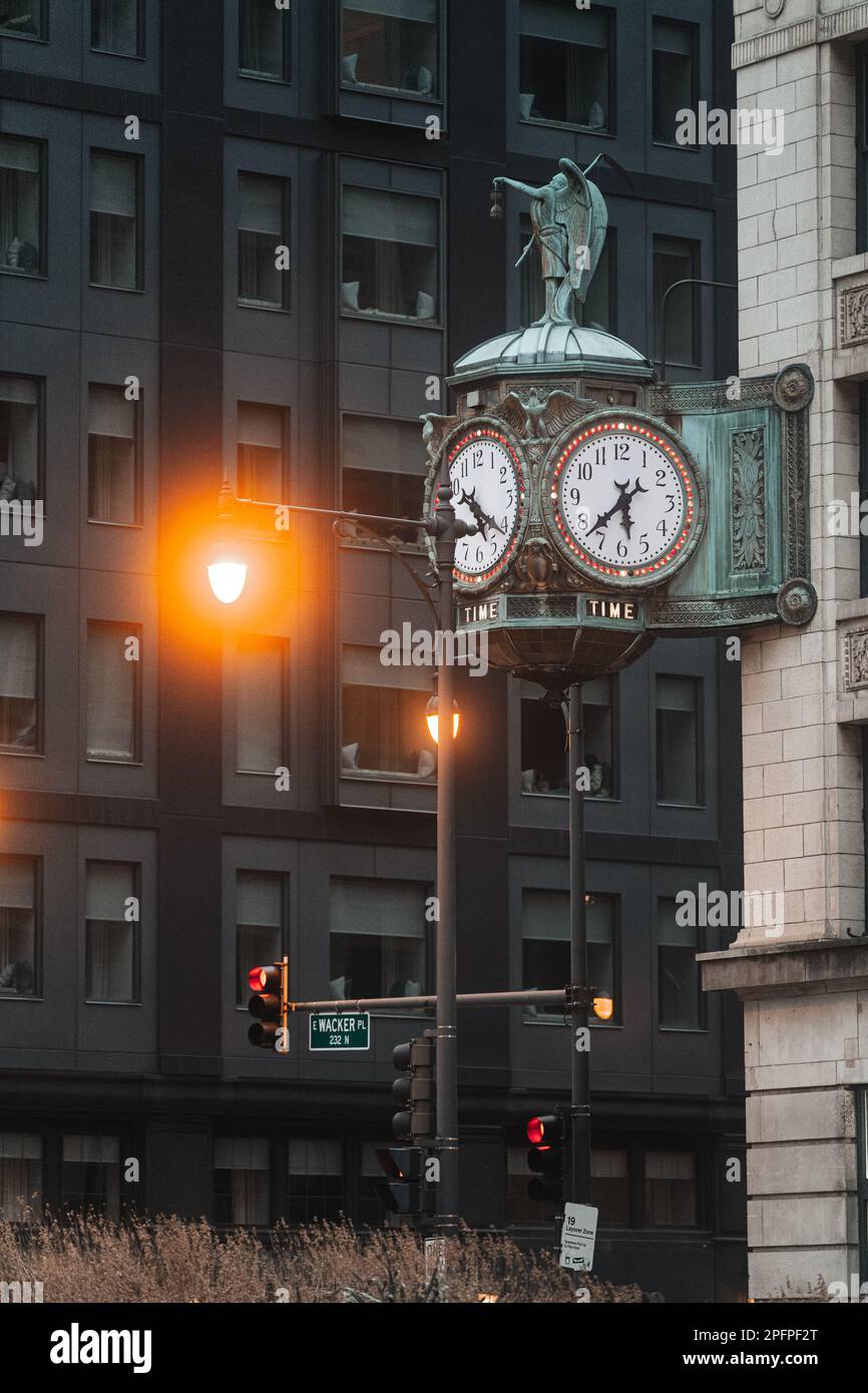 An ornate clock and statue are prominently displayed in front of a ...