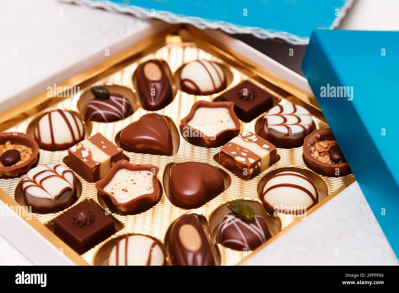 Close up of open small gift box of Swiss chocolate candies. Luxurious ...