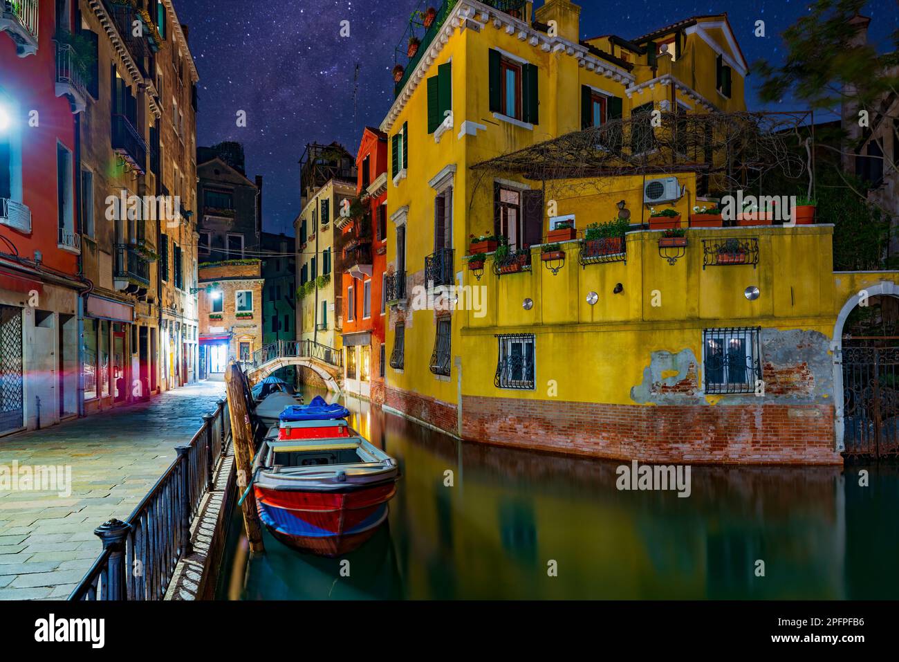 Romantic streets and canals of Venice at night. Colorful houses and ...