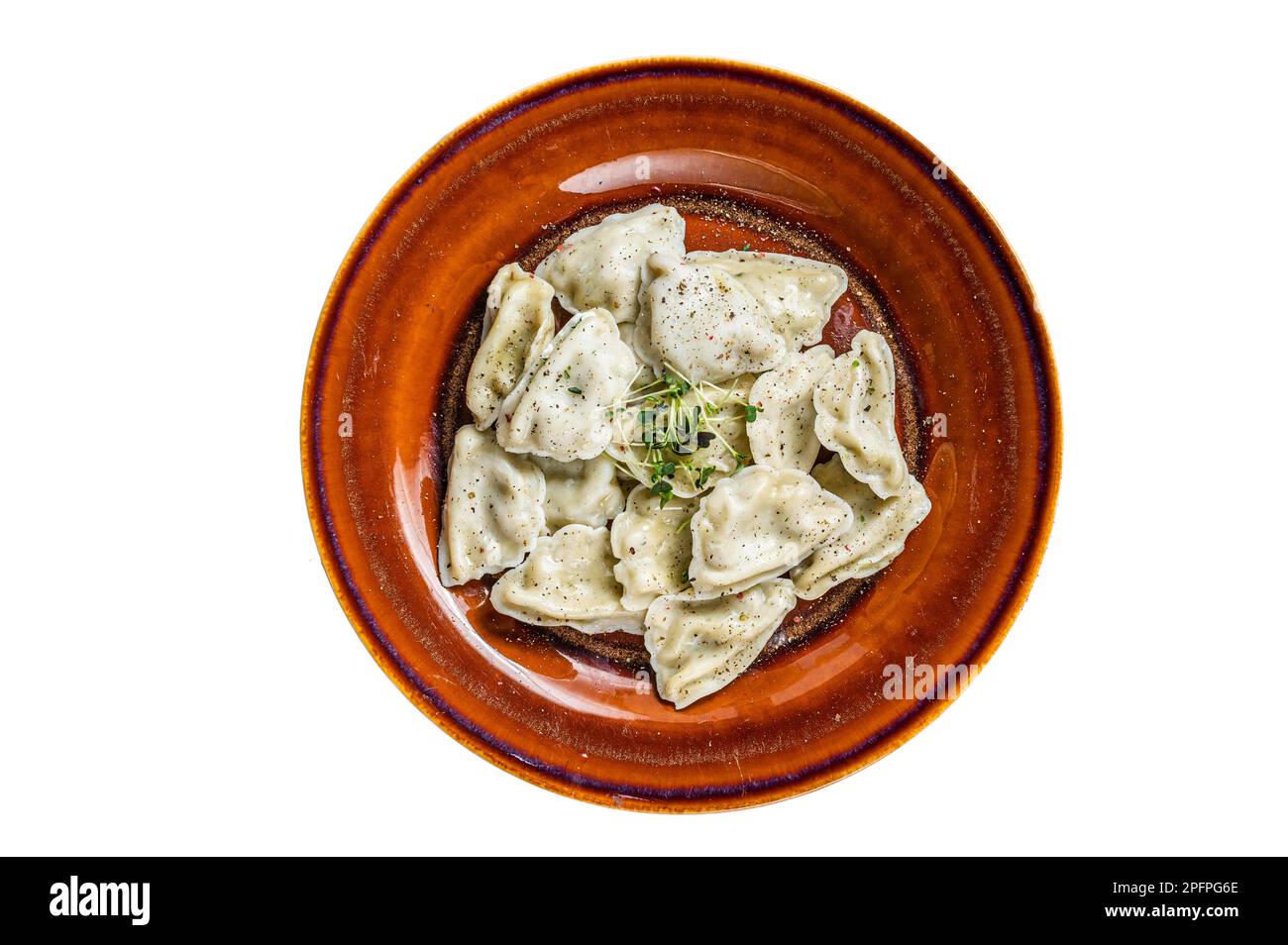 Polish Pierogi Dumplings with potato in a plate with herbs and butter ...